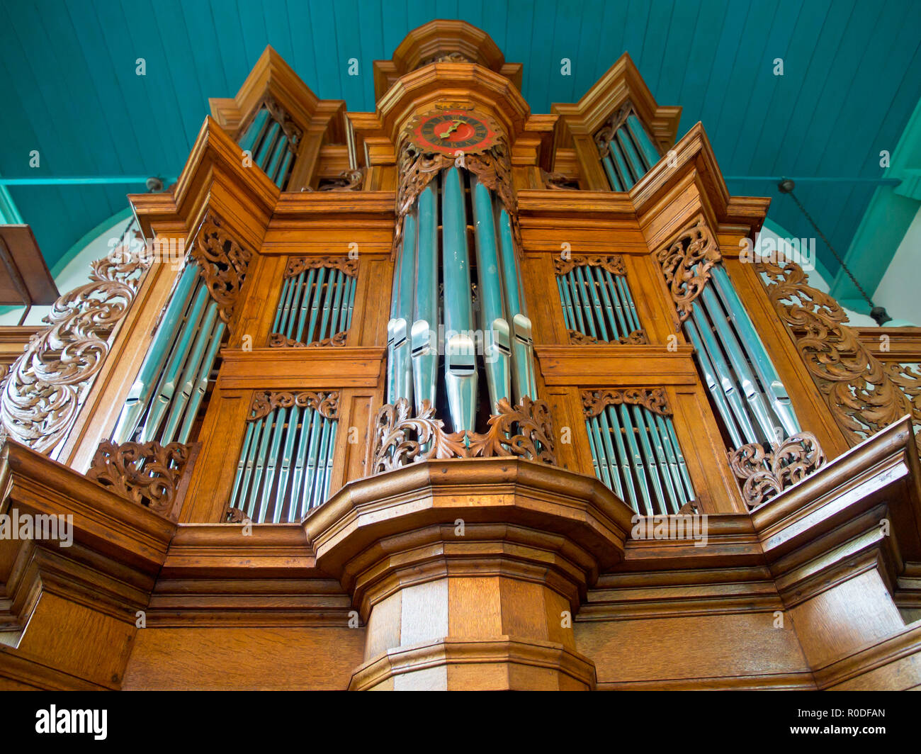 Wooden church organ against blue ceiling Stock Photo - Alamy