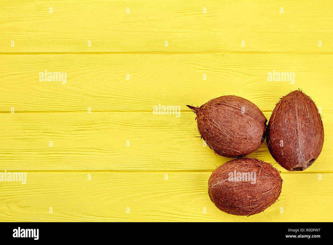 Three whole coconuts and copy space Stock Photo - Alamy