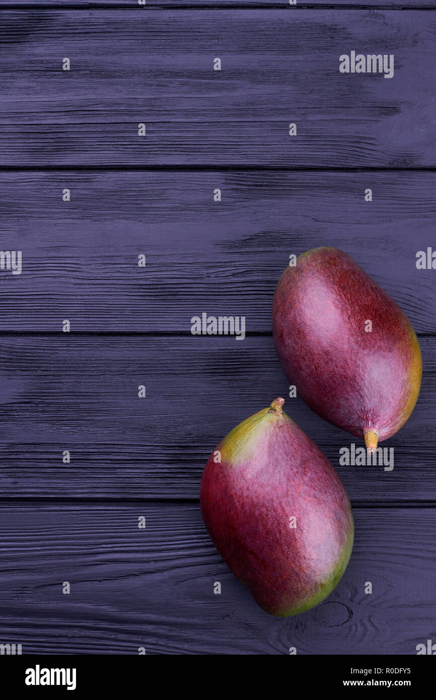 Tropical fruits on wooden background Stock Photo - Alamy