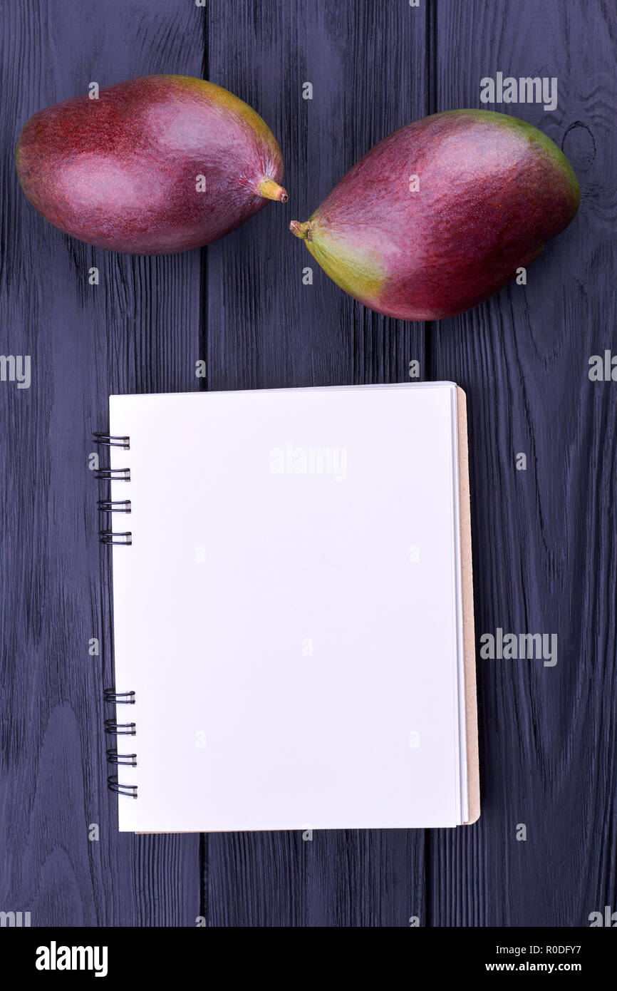 Mango fruits and blank spiral notepad Stock Photo - Alamy
