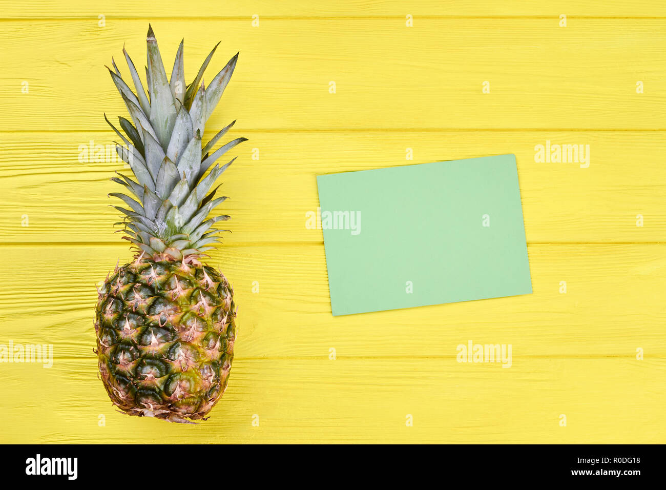 Whole pineapple and blank paper card Stock Photo - Alamy