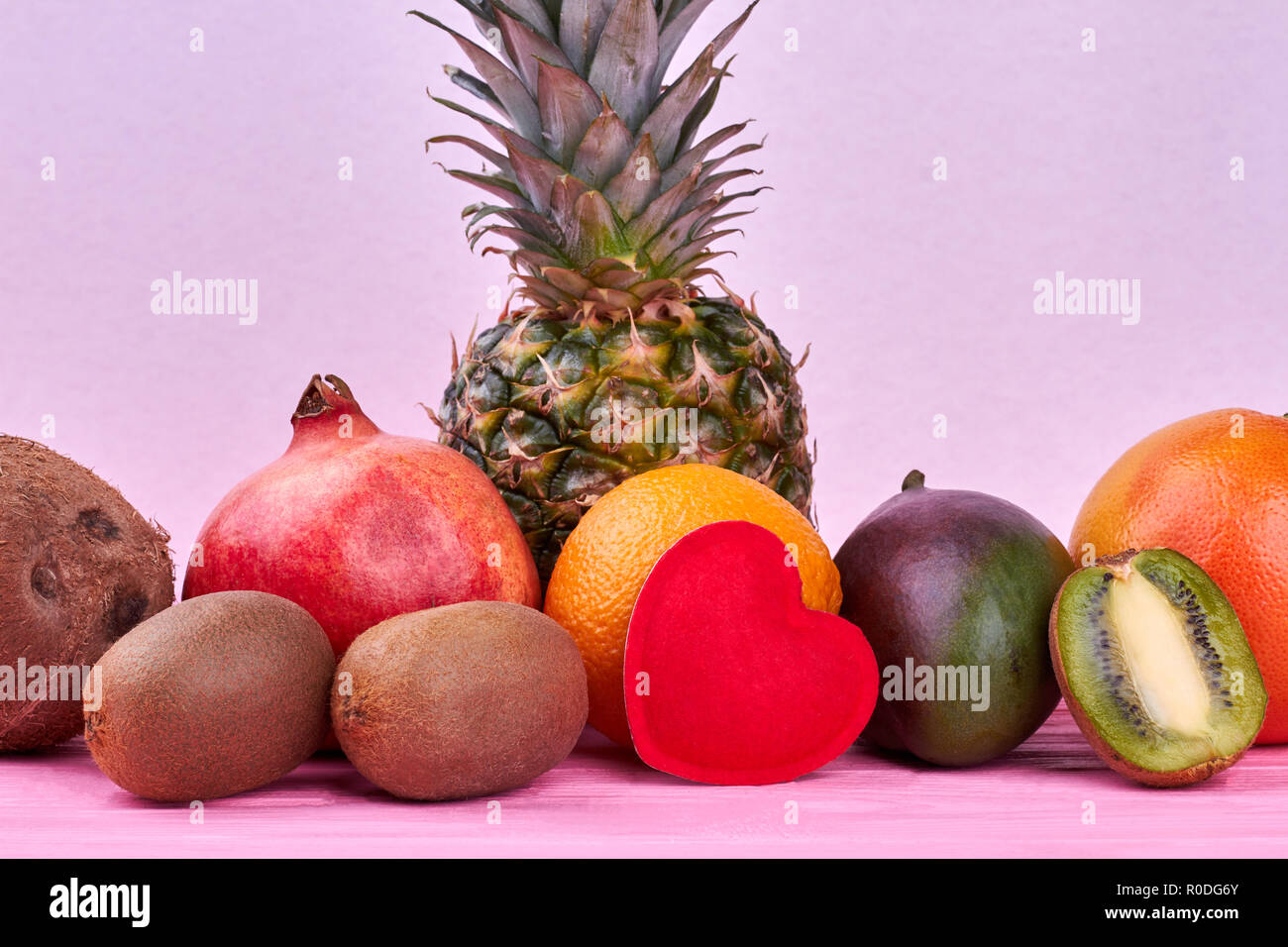 Composition from exotic fruits on pink background Stock Photo - Alamy