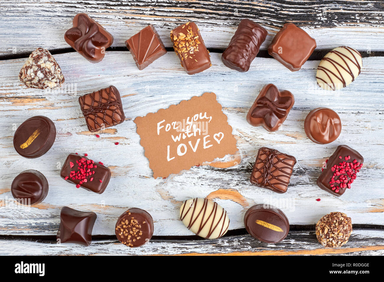 Collection of chocolate candies on wooden background Stock Photo - Alamy