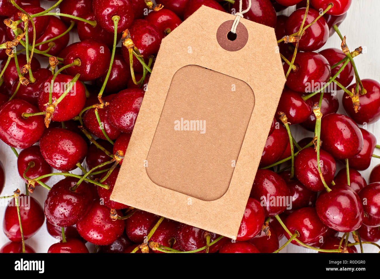 Red cherries and blank price tag Stock Photo - Alamy