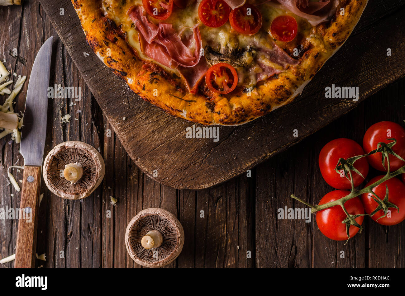 Rustic old style vintage pizza, wood board, fresh food Stock Photo - Alamy