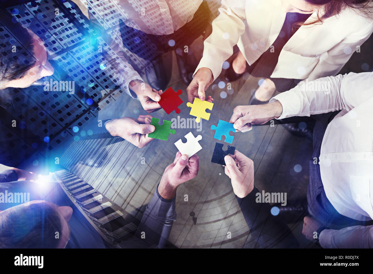 Business people join puzzle pieces in office. Concept of teamwork and ...