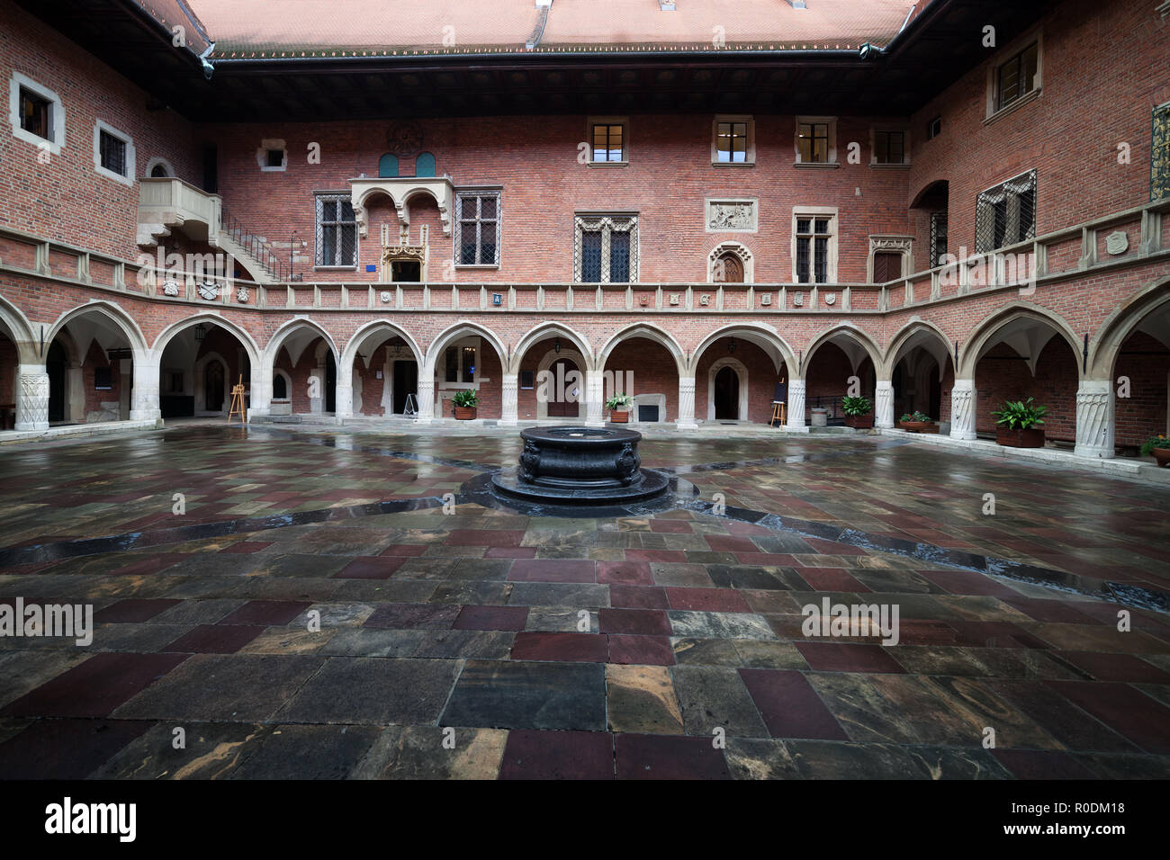 Collegium Maius arcade courtyard with well in city of Krakow in Poland ...
