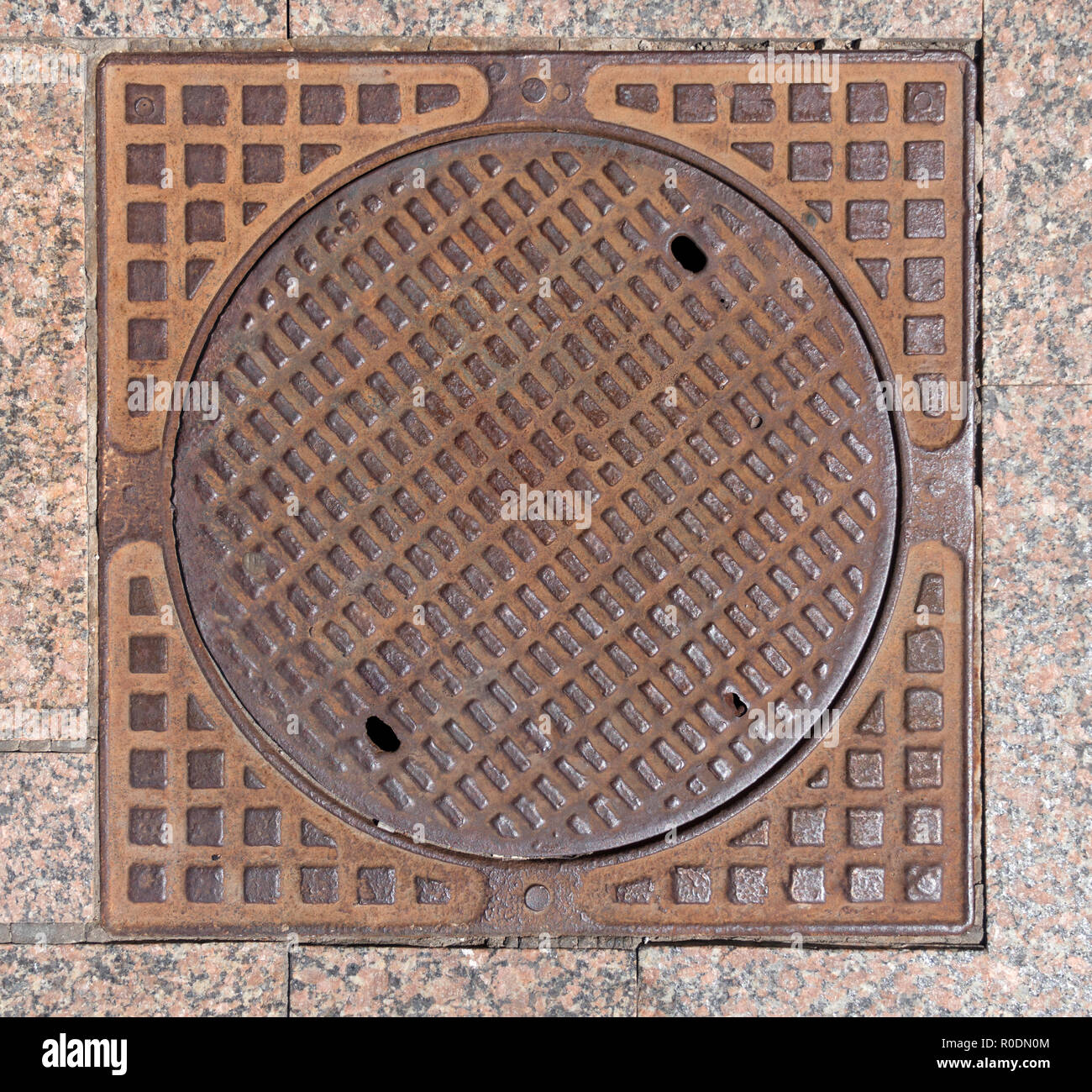 Old rusty sewer hatch on an old metal plate. View from above Stock ...