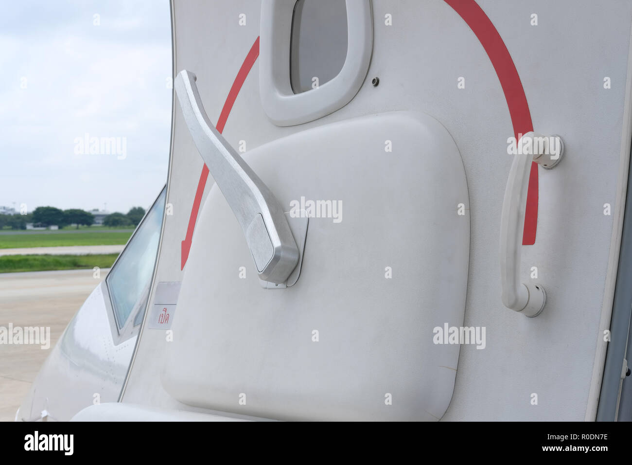 opening airplane aircraft emergency exit door at airport Stock Photo ...