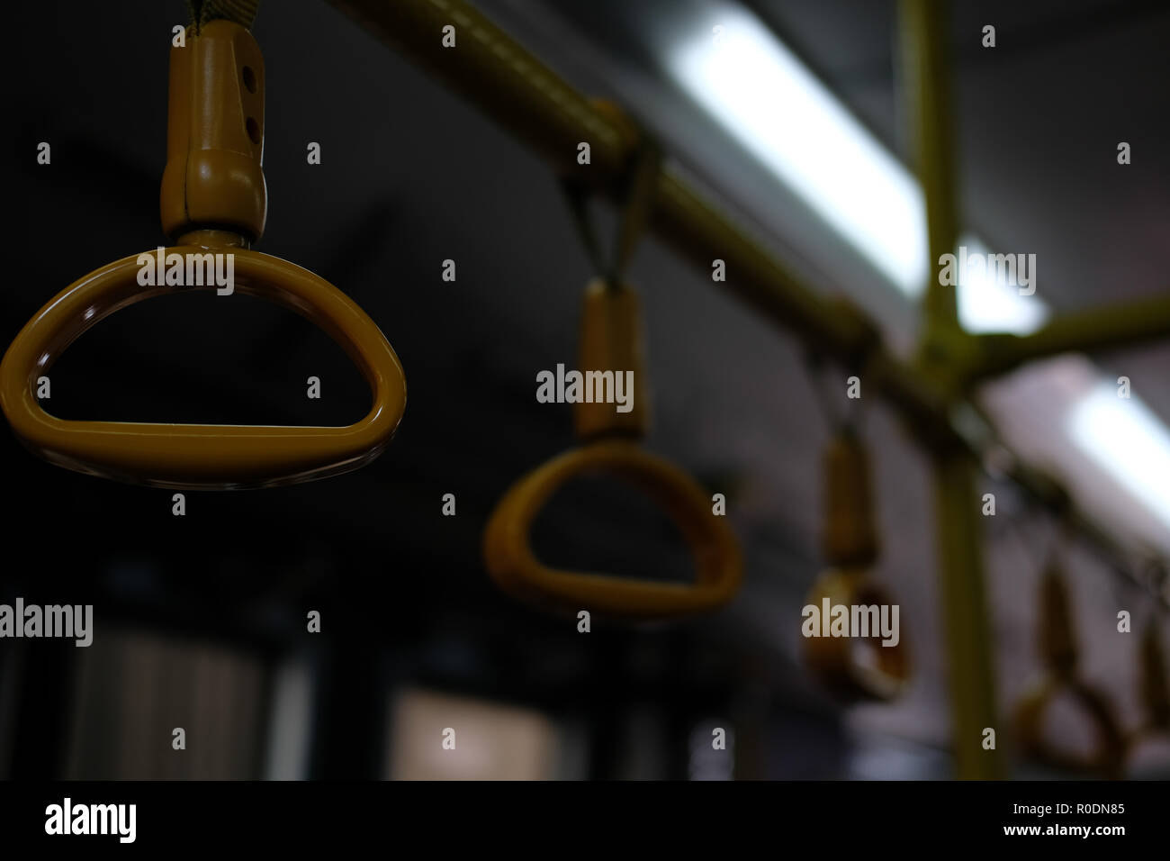yellow handle on commuter bus at night. public transport Stock Photo ...