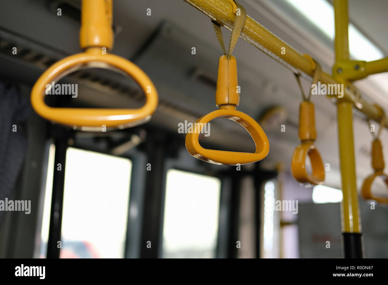 yellow handle on commuter bus. public transport Stock Photo - Alamy