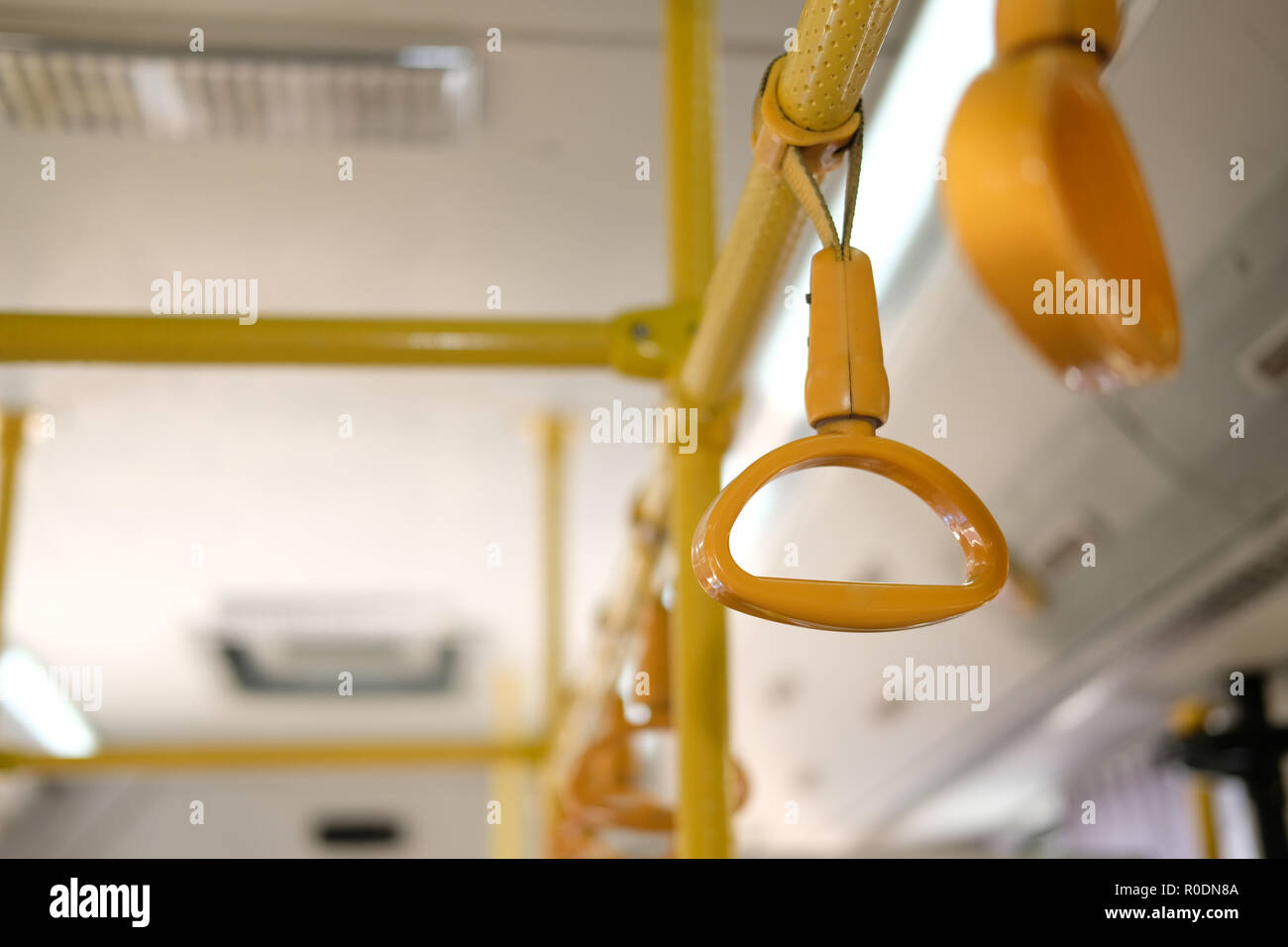 yellow handle on commuter bus. public transport Stock Photo - Alamy