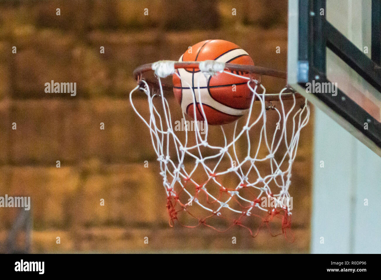 Basketball going into the hoop at a local basketball game Stock Photo ...