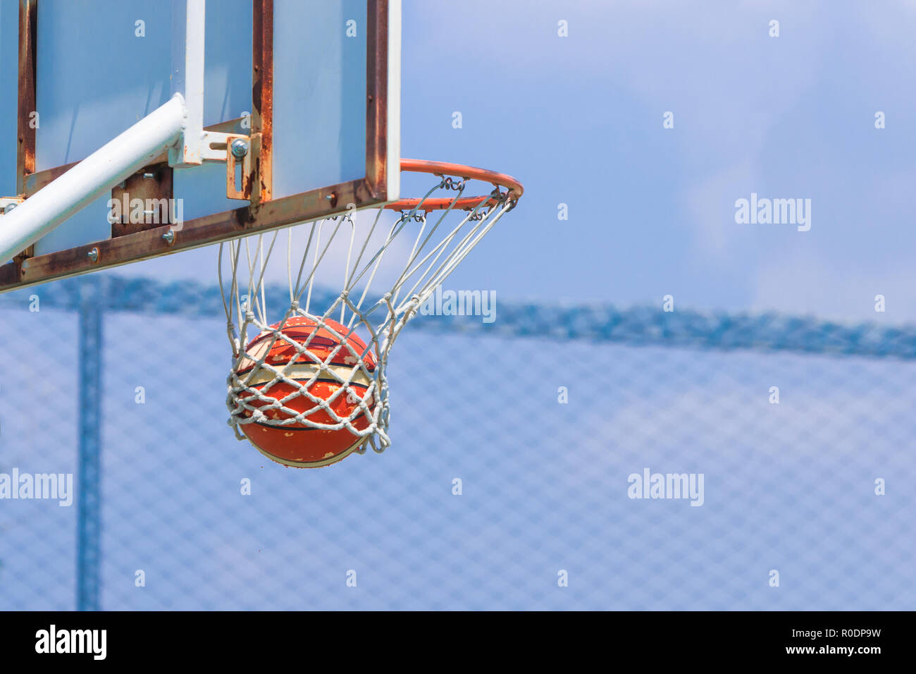 Basketball going into the hoop at a local basketball game Stock Photo ...