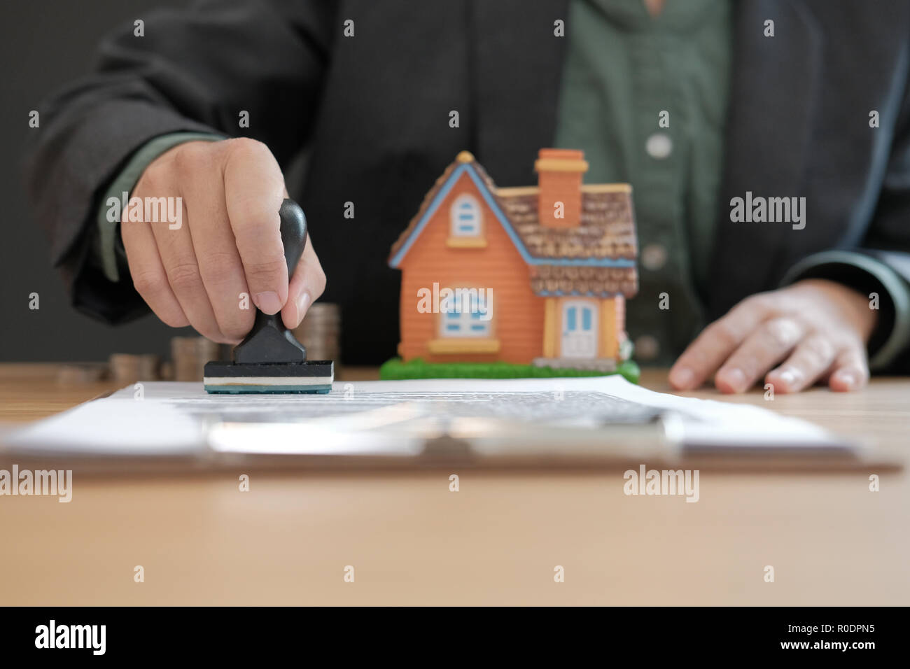 real estate agent using stamper for stamping approved on mortgage loan ...