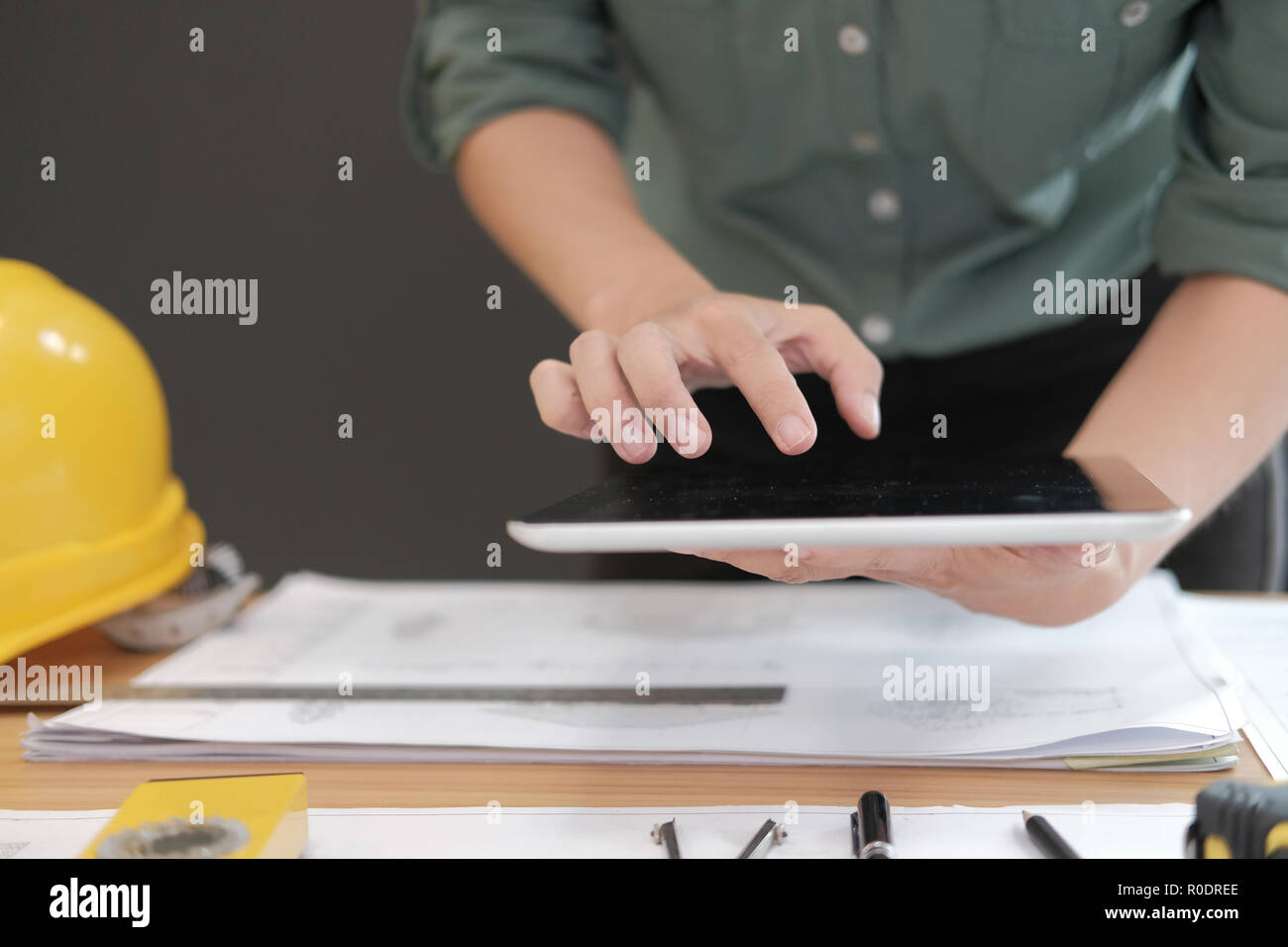 architect using tablet. engineer working on house blueprint of real ...