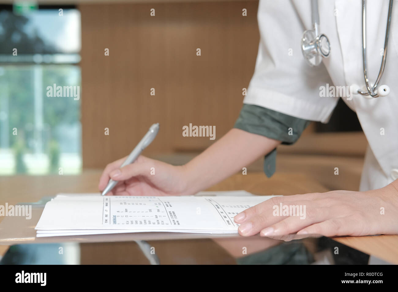 doctor physician writing medical examination or prescription note at ...