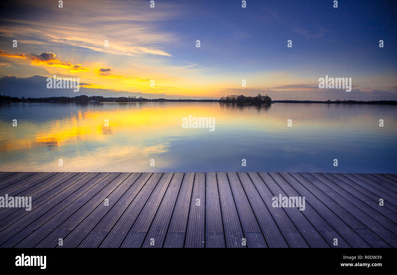 Wooden recreational swimming deck on the lakeside during spectacular ...