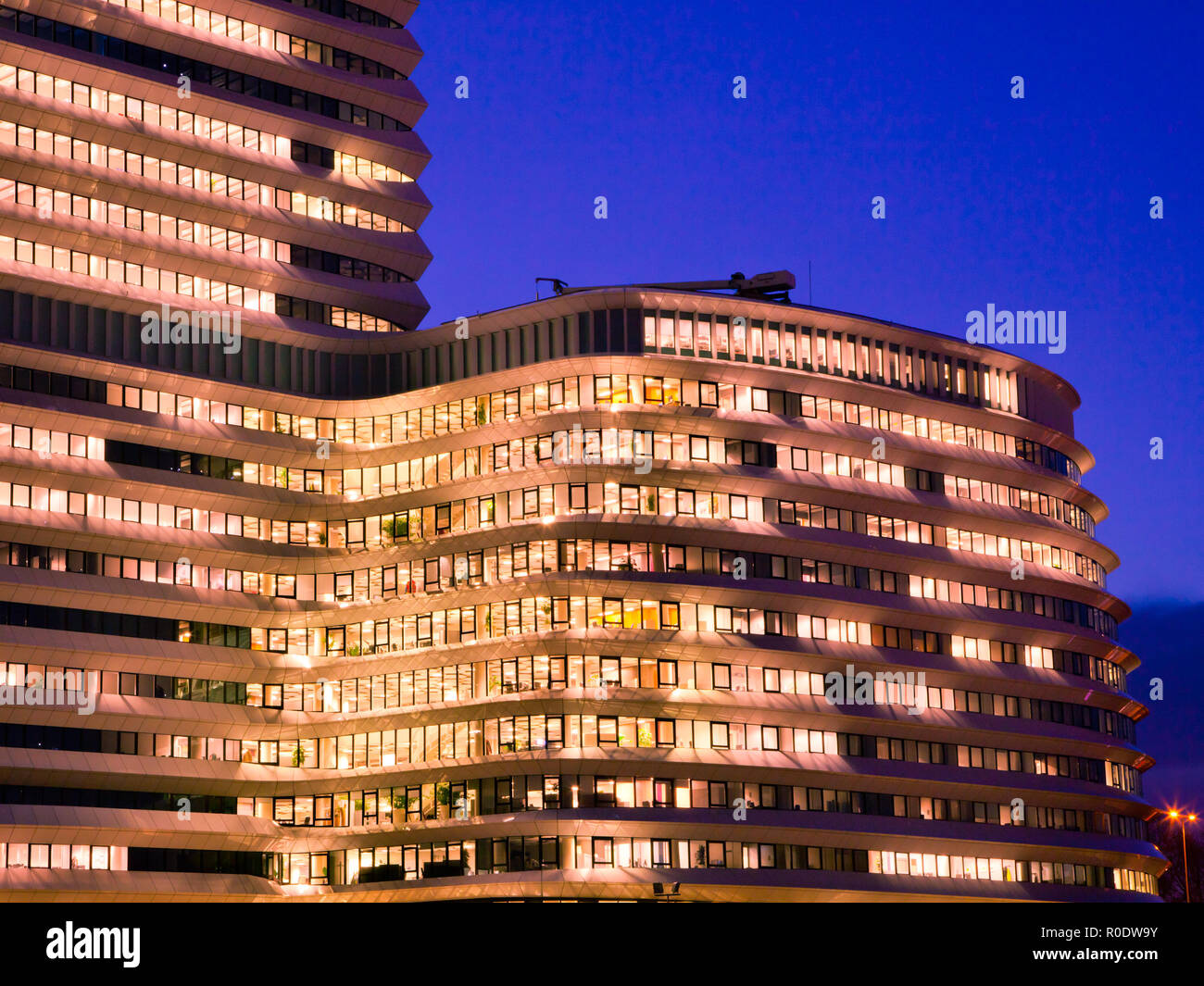 Long Working Hours in a Tall Modern Office Building with Lights during ...