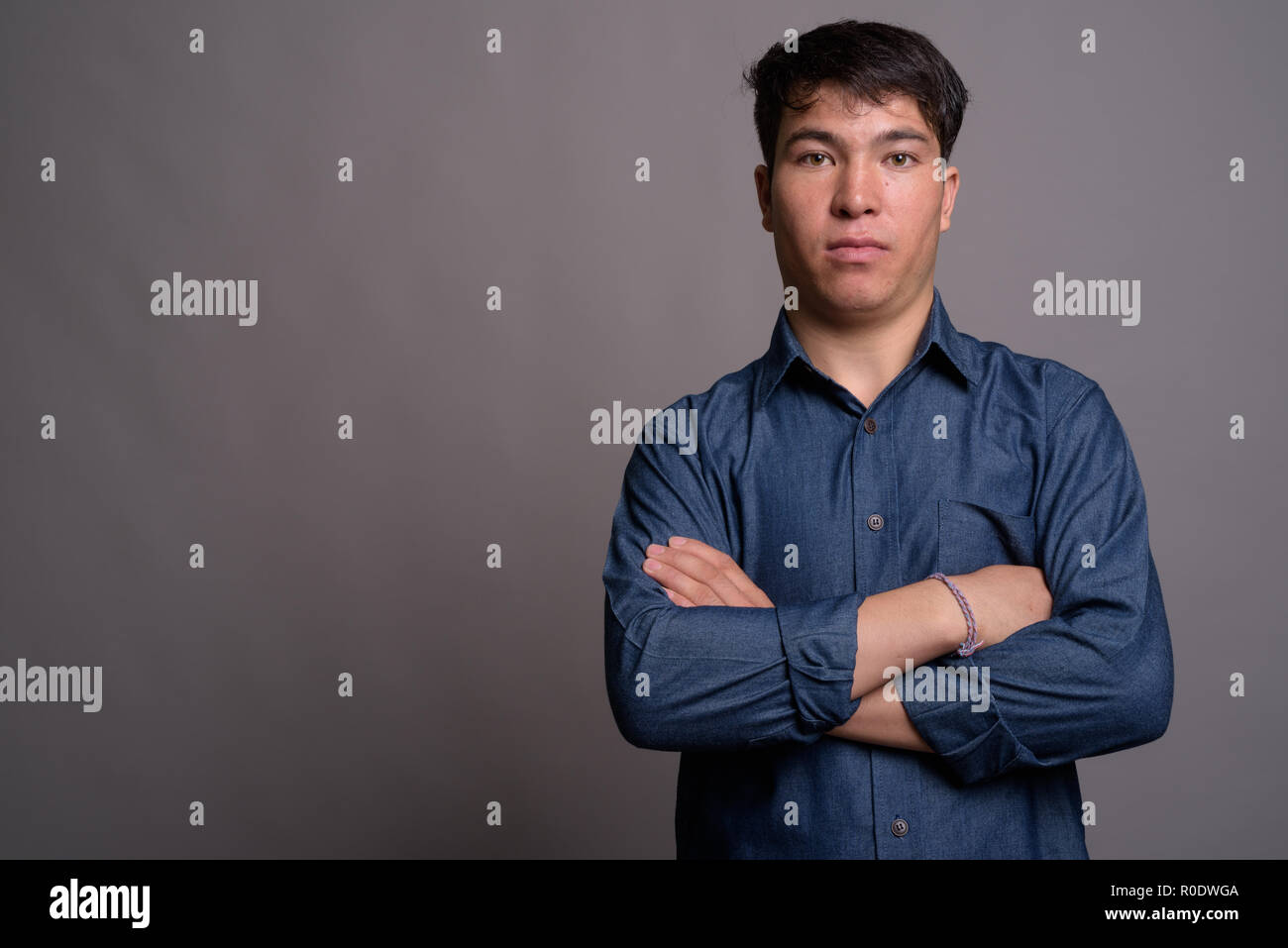 Young man wearing blue shirt hi-res stock photography and images - Alamy