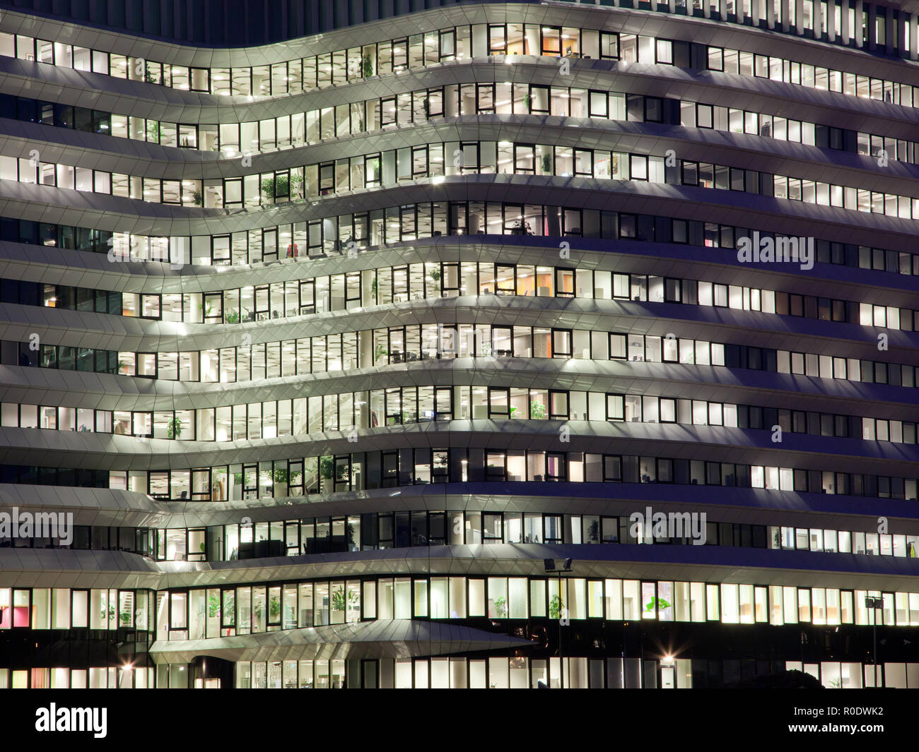Long Working Hours in an Office Building with Lights at Night in the ...