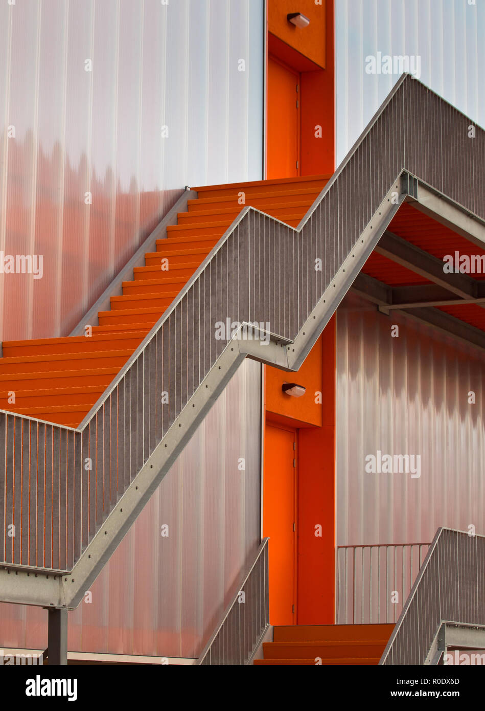 Orange escape stairs on the outside of a modern building Stock Photo ...