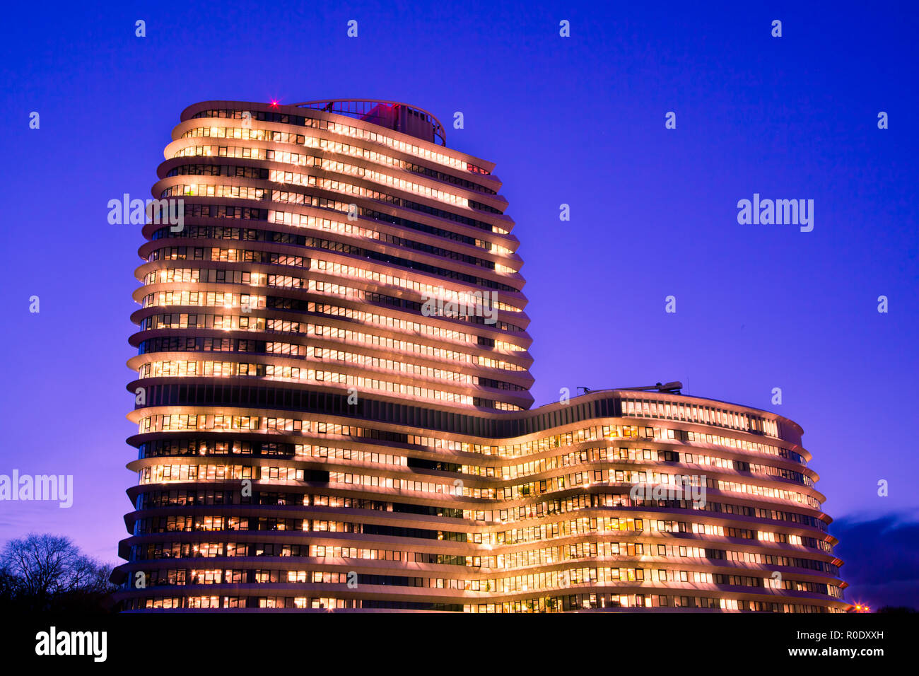 Long Working Hours in a Tall Modern Office Building with Lights during ...