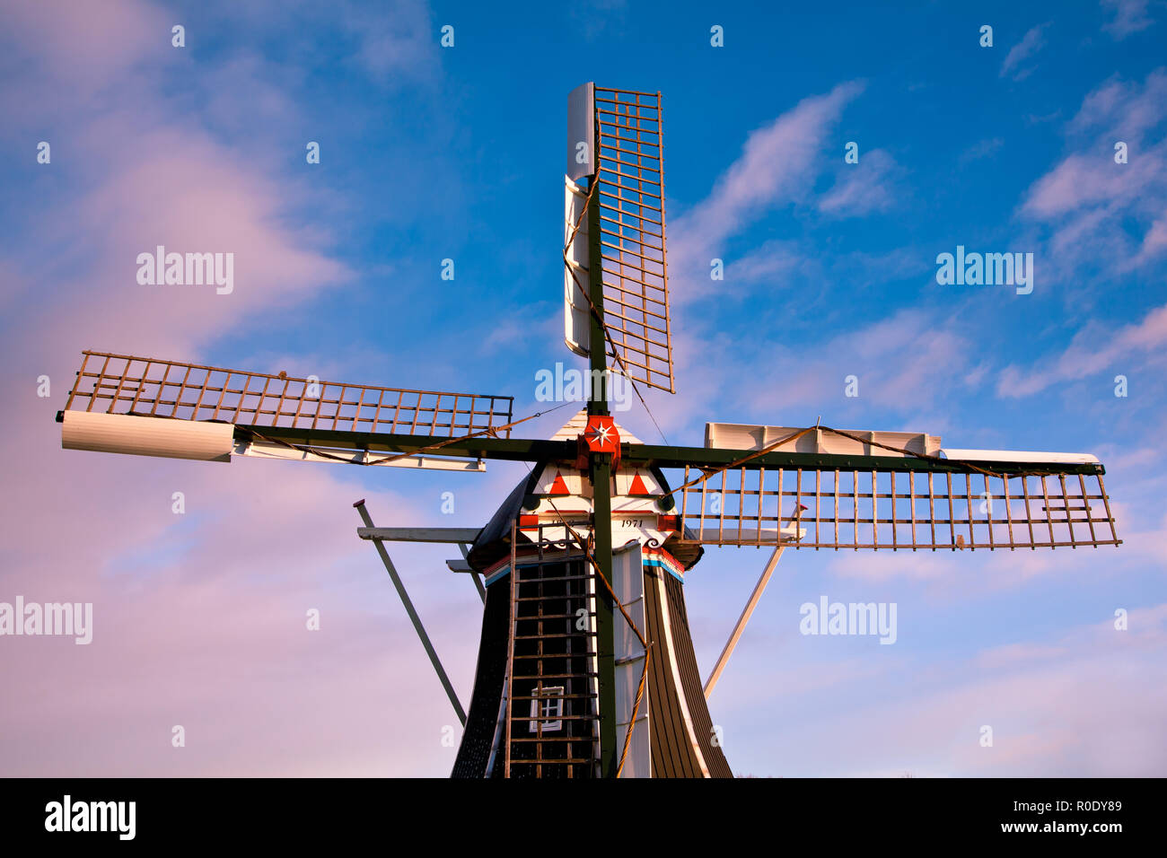 Dutch Windmill on the Waterfront of a Lake with Spectacular Clouds ...