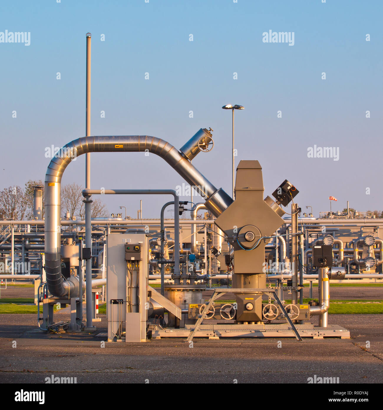 Natural gas well processing plant backdrop during sunset Stock Photo ...