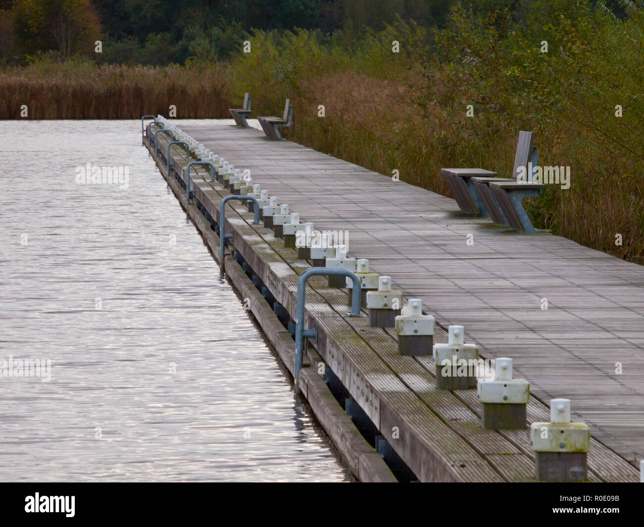 A modern wooden jetty with bench Stock Photo - Alamy