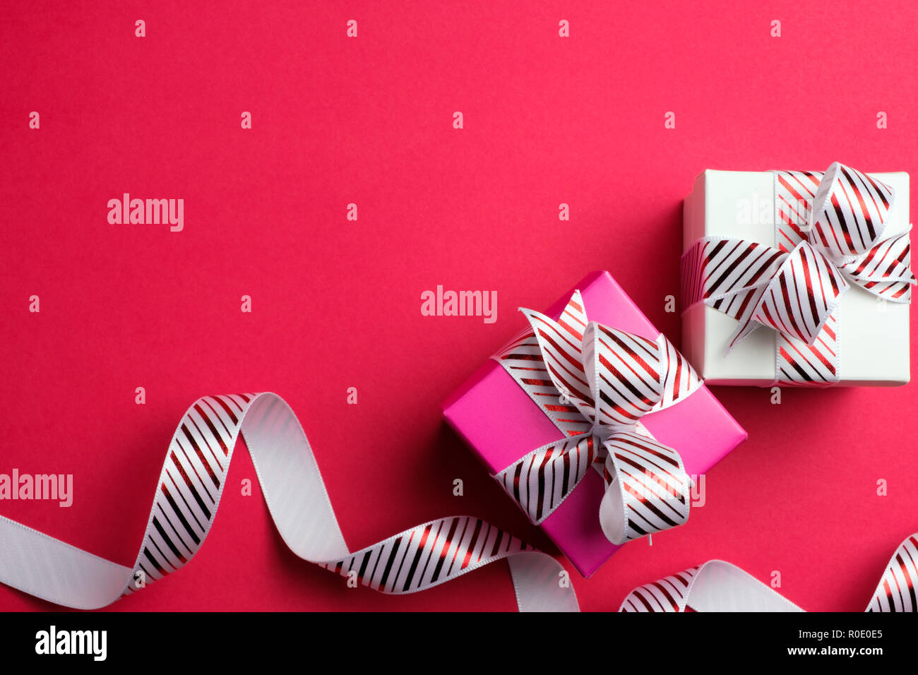 White and pink gift boxes with stripe ribbon Stock Photo - Alamy