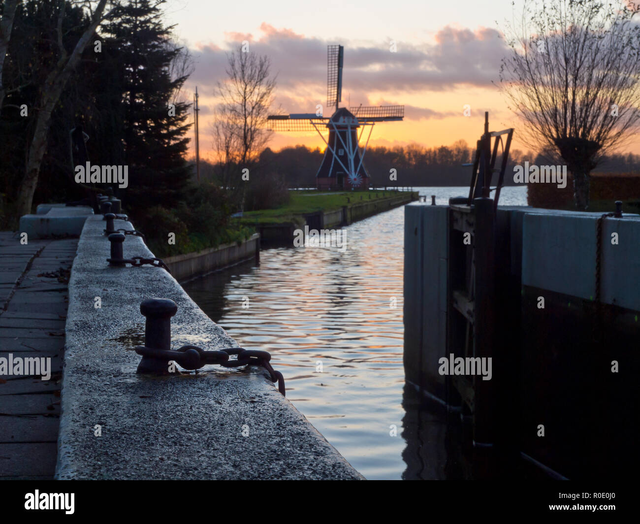Vintage windmill backdrop during sunset with lock chamber foreground ...