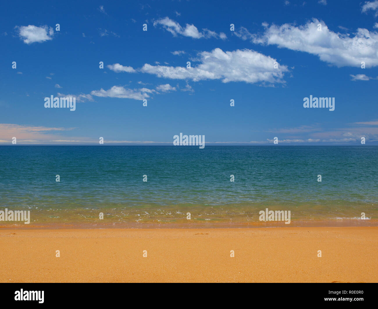 A tropical blue sea with golden sand beach and a perfect sky Stock ...