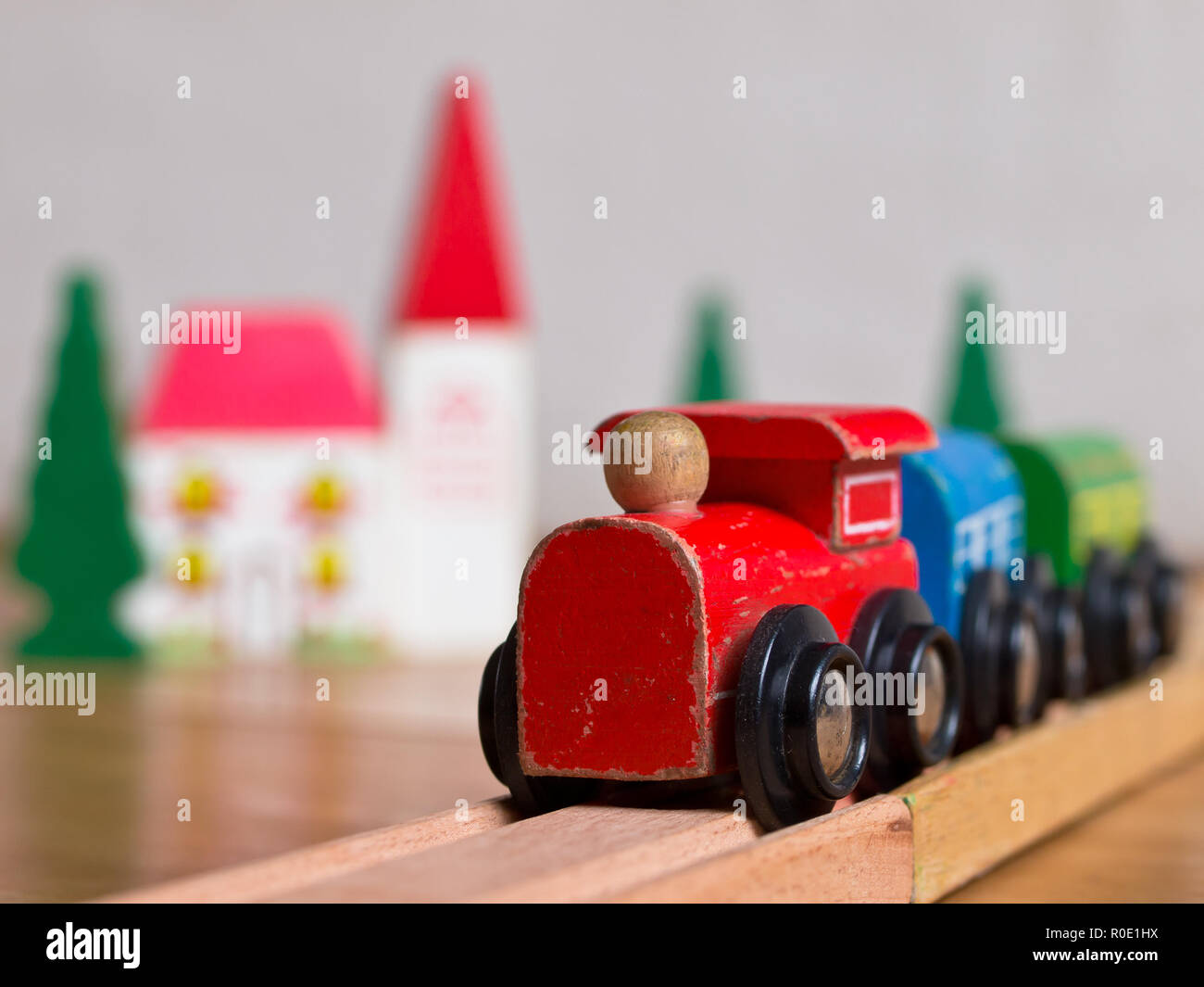 Wooden toy train with village and bridge in backdrop Stock Photo - Alamy