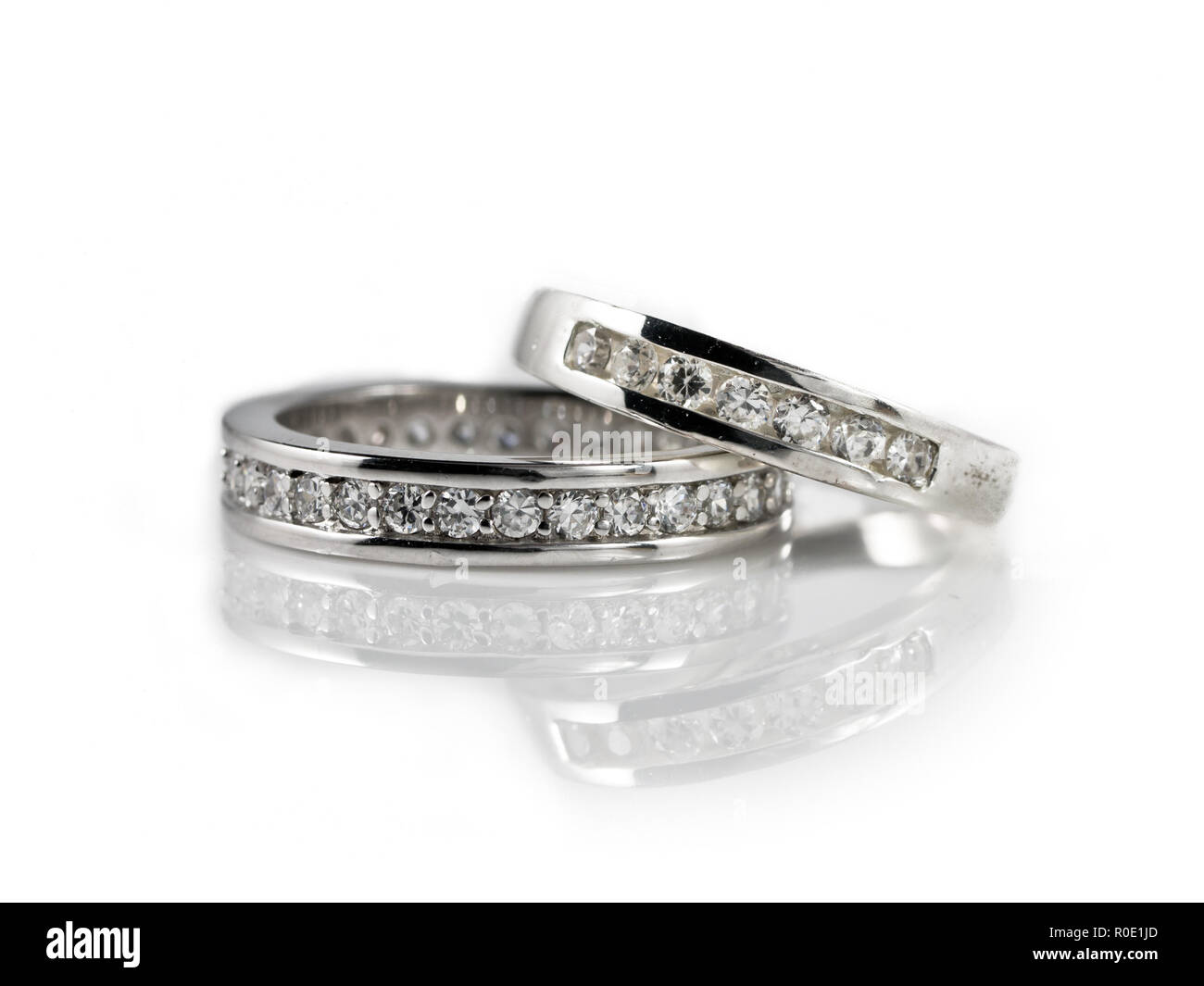 Two engagement rings on white background Stock Photo - Alamy