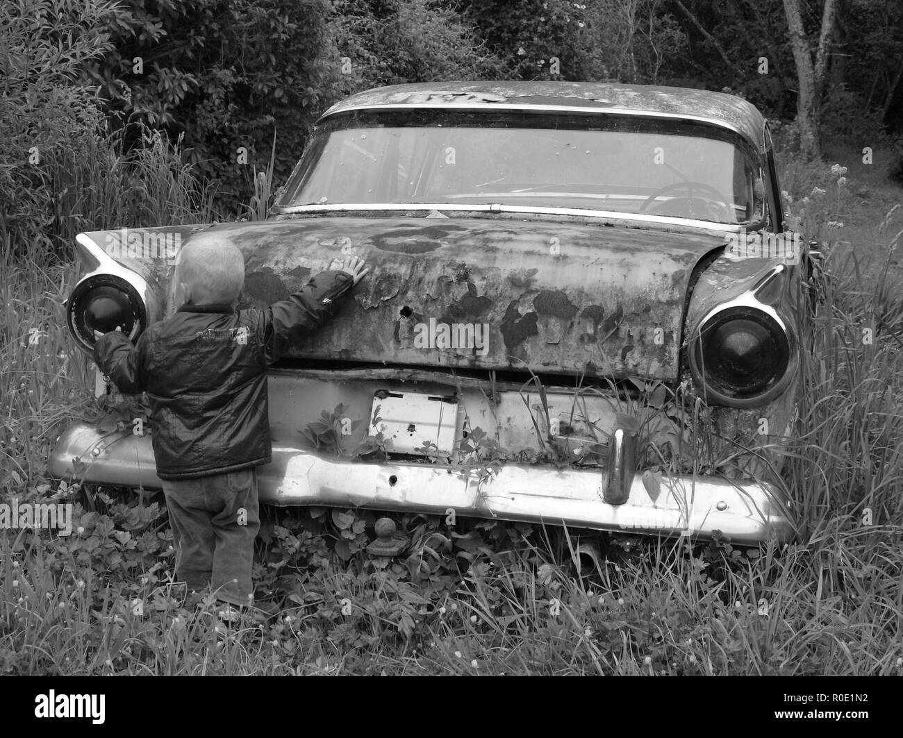 A little boy is touching an old car Stock Photo - Alamy
