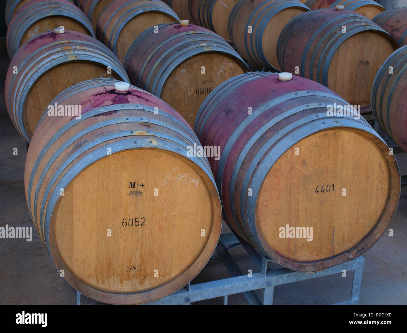 Wine barrels in arrangement waiting in a cellar Stock Photo - Alamy