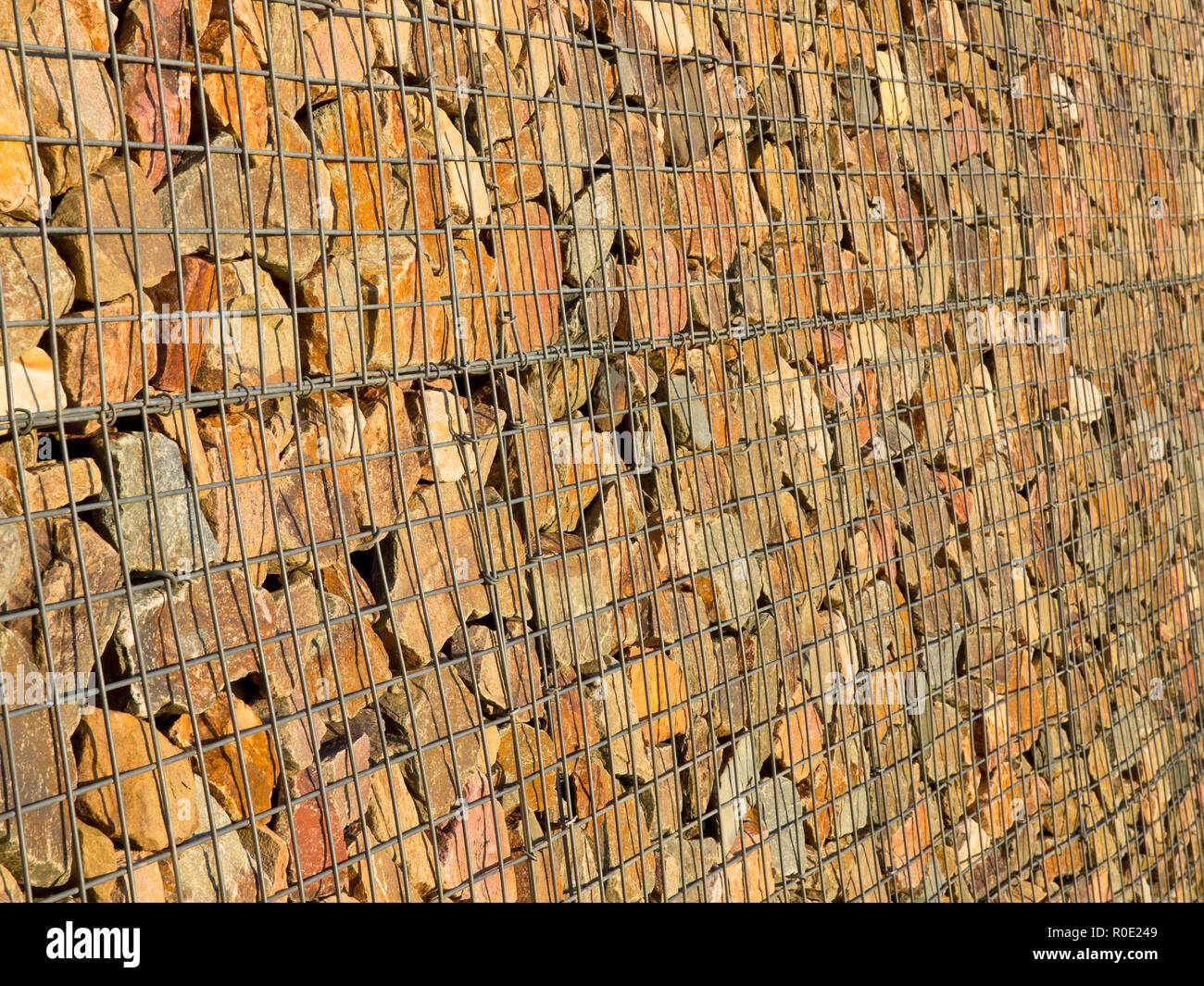 Wall made up of stone baskets background Stock Photo - Alamy