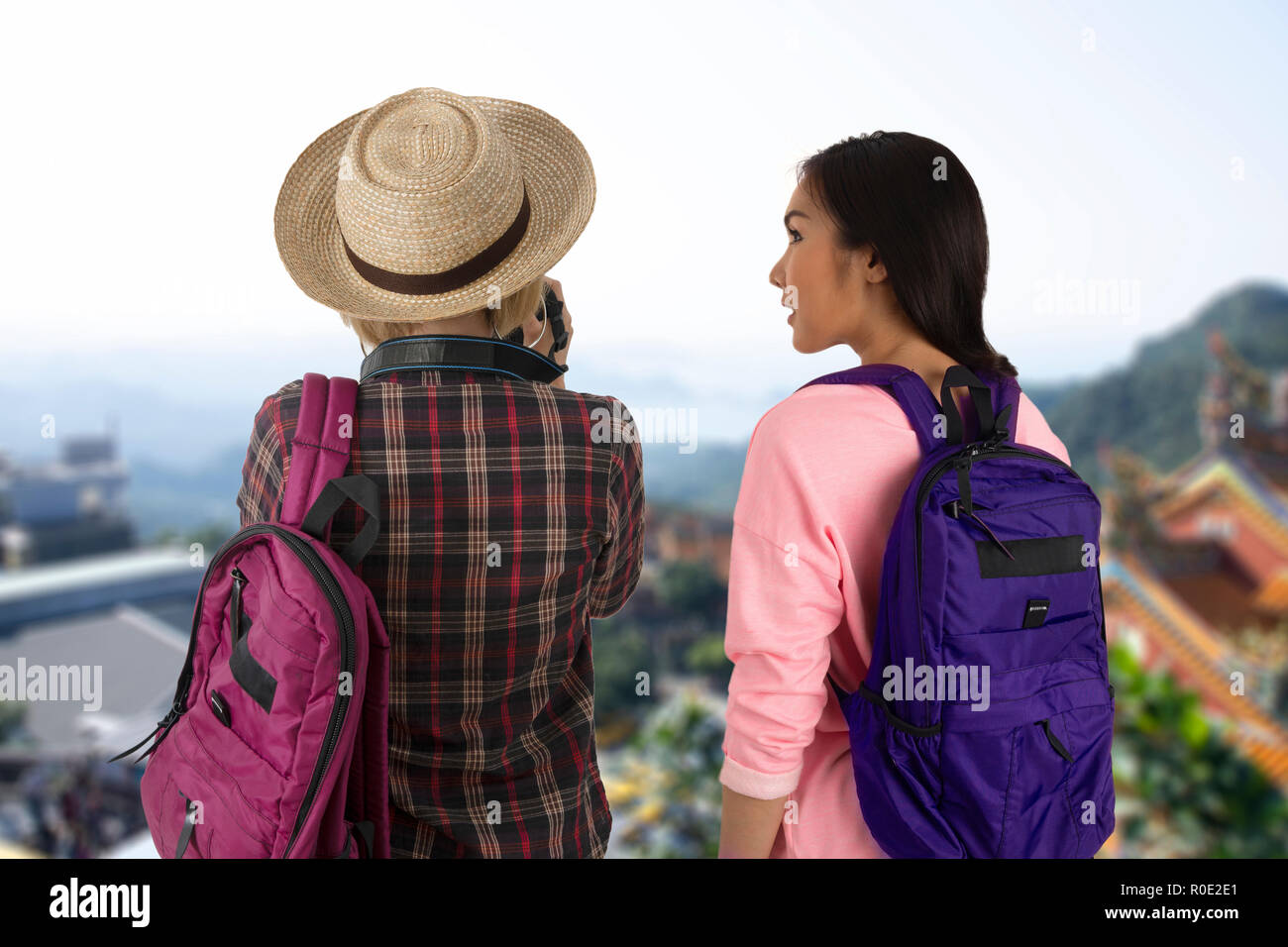 Back view of two female tourists are taking pictures of beautiful ...