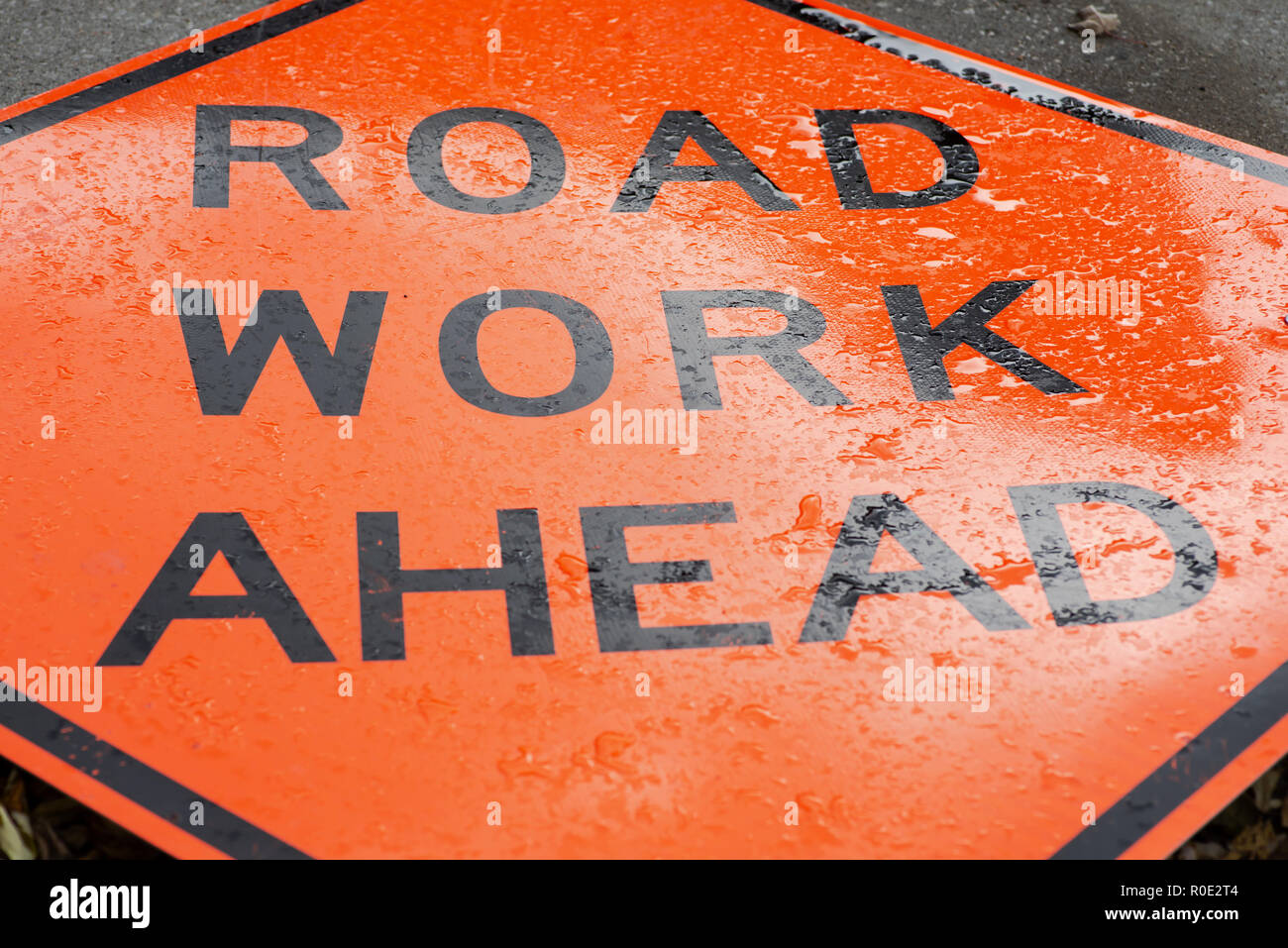 Broken Road Work Ahead sign on concrete sidewalk during roadwork Stock ...