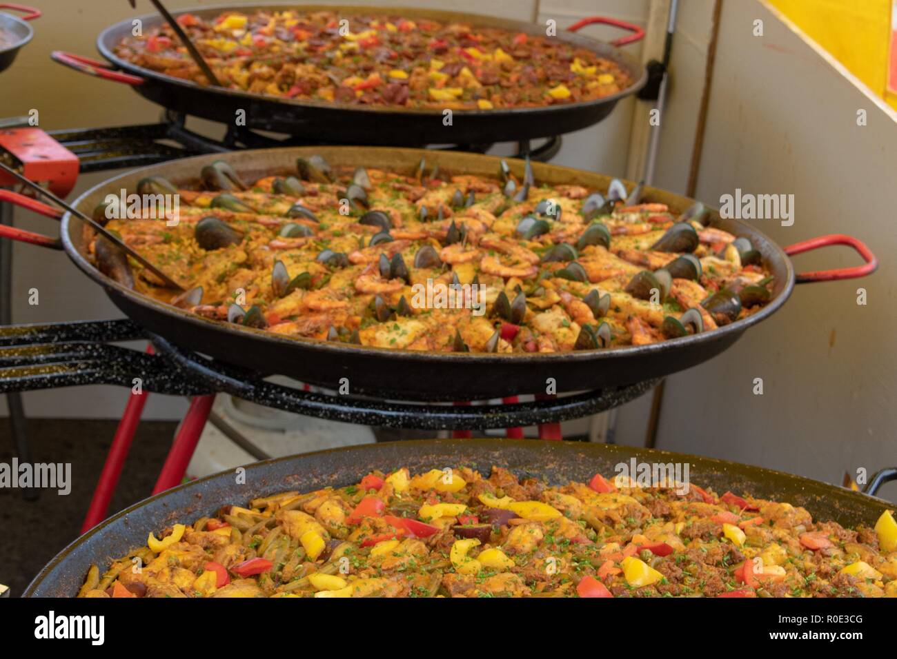 Display of three pans of Spanish Paella st the street food festival ...