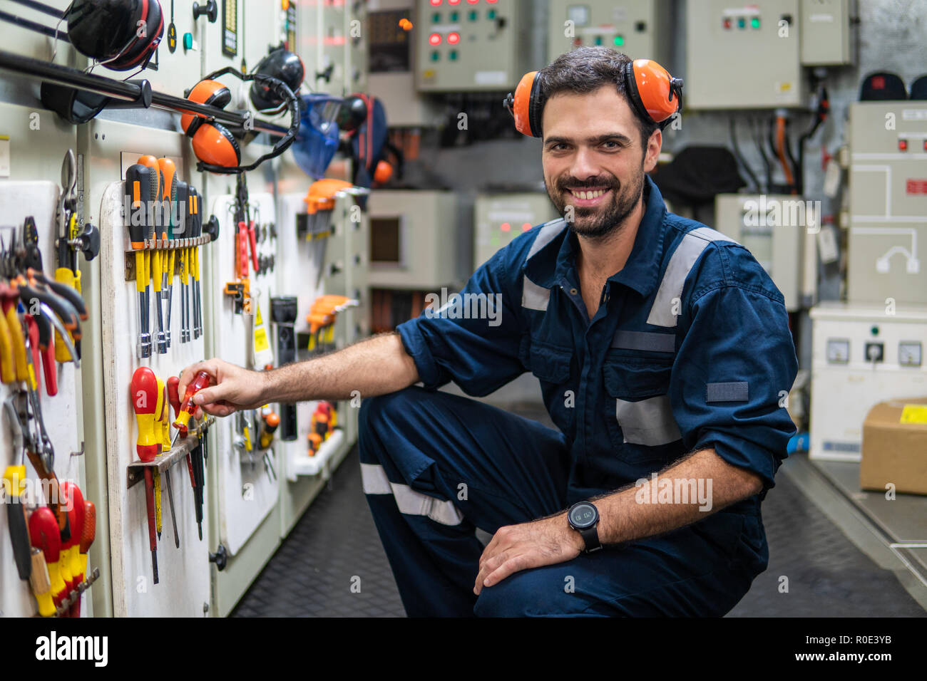 Marine engineer officer working in engine room Stock Photo - Alamy