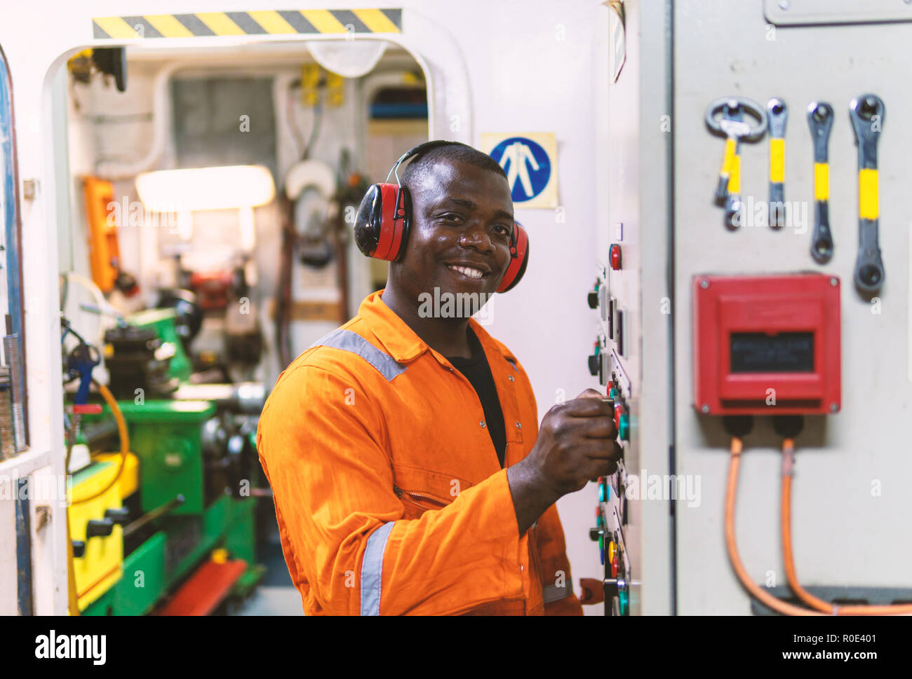 Marine engineer officer working in engine room Stock Photo - Alamy