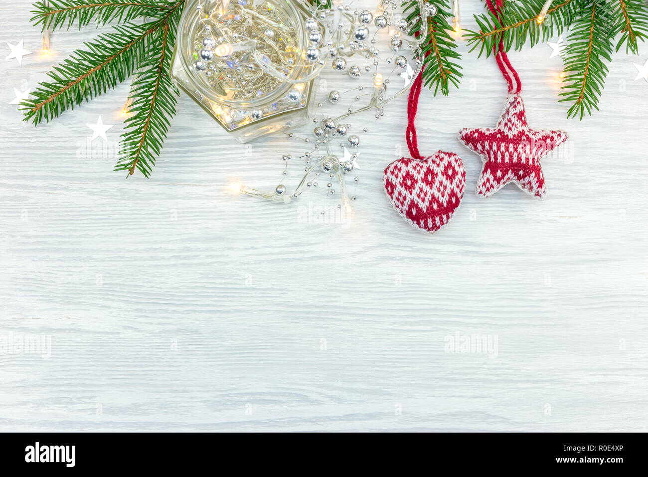 decorative wool baubles with garland lights and christmas tree branch ...
