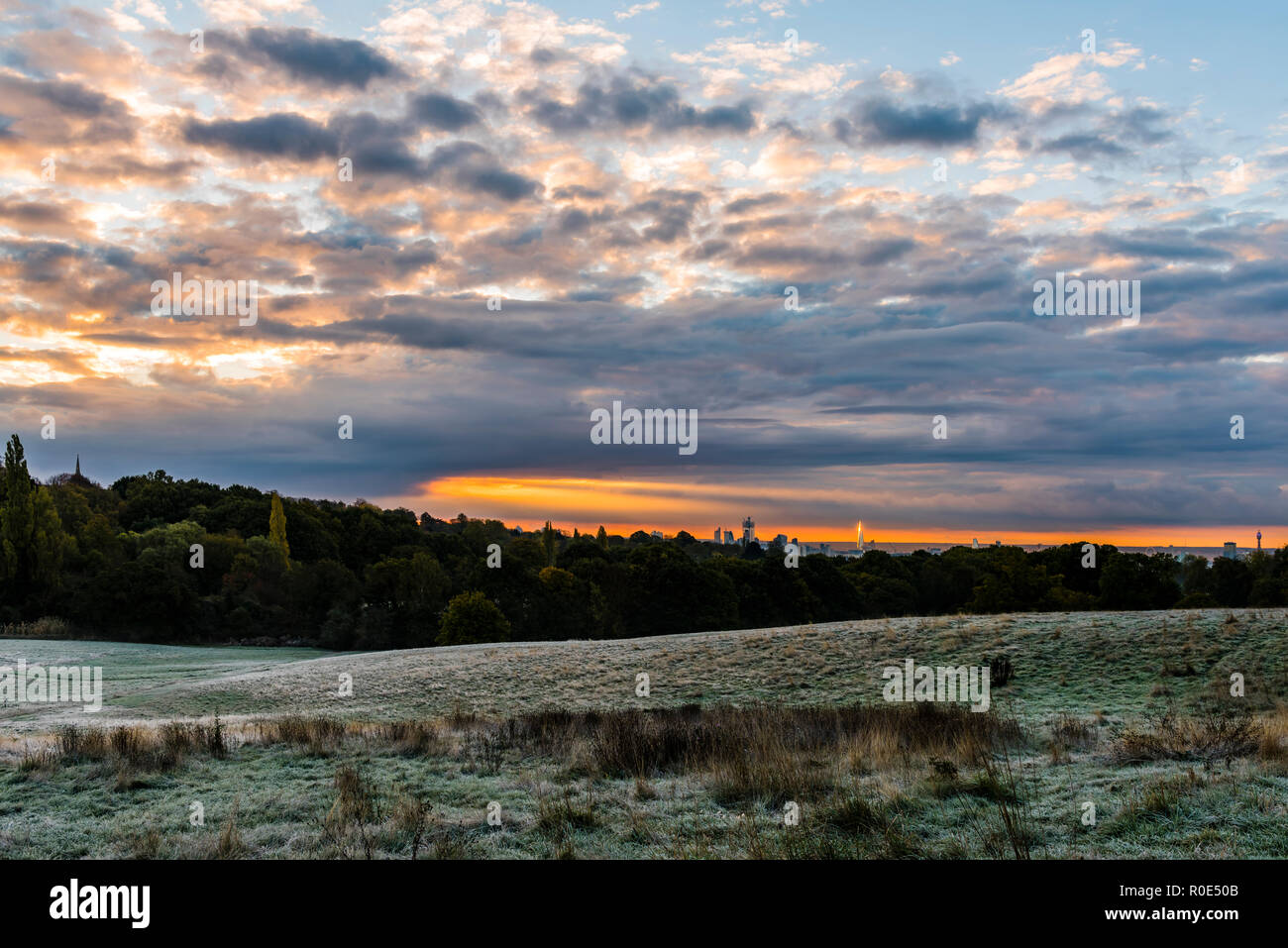 Orange glow over the London skyline from Hampstead Heath, London, UK ...