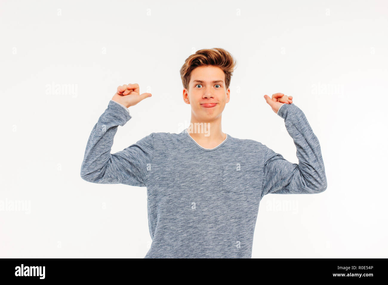 Smiling young guy welcomes saying goodbye to hand on white background ...