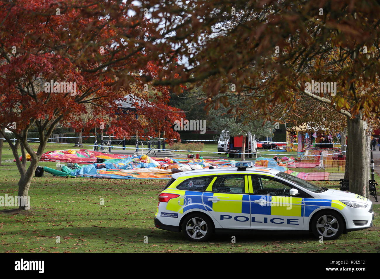 A deflated inflatable slide sits on the ground in Woking Park, Surrey ...