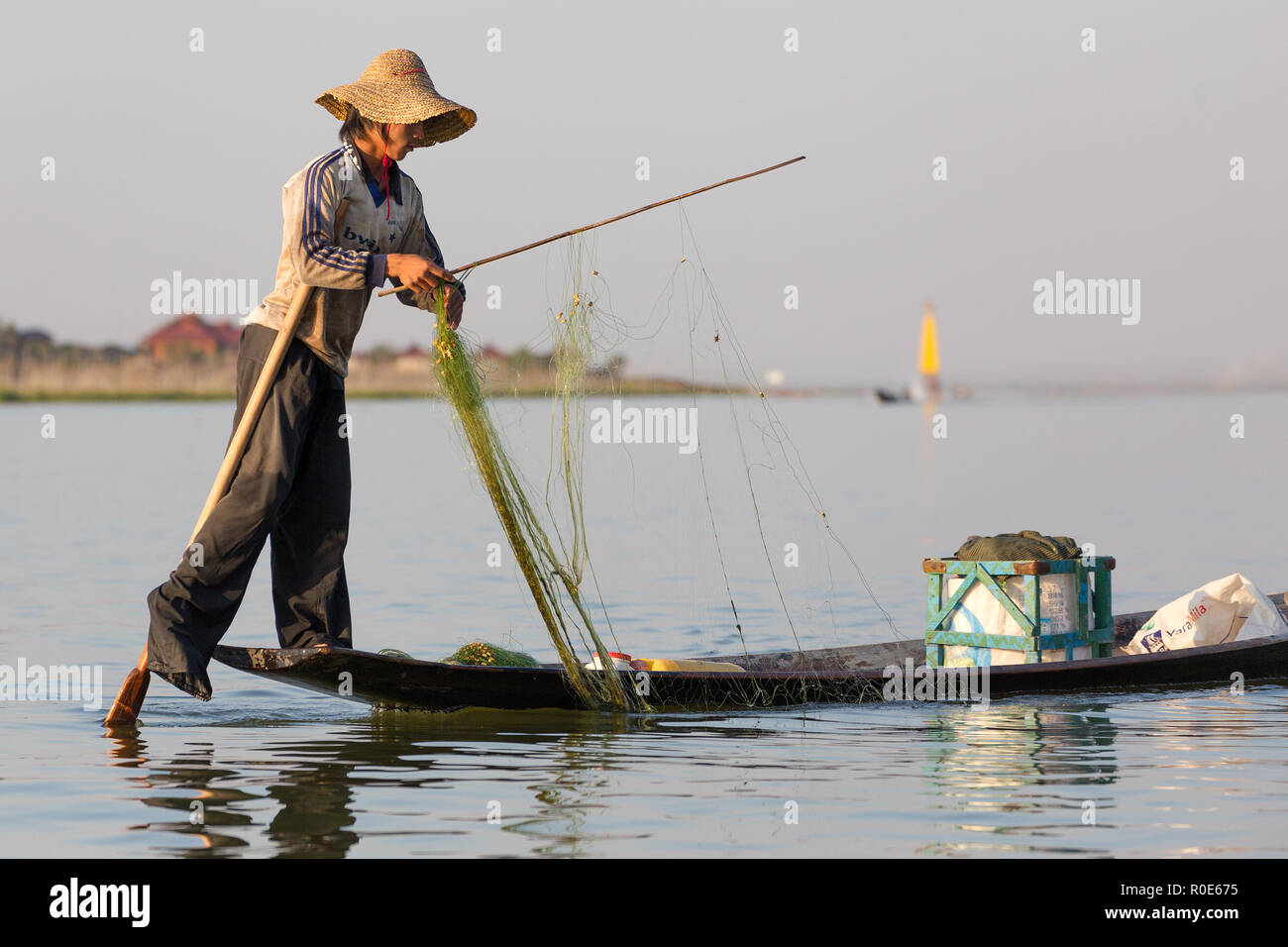 INLE LAKE, MYANMAR, JANUARY 26, 2015 : A fisherman showing the special ...