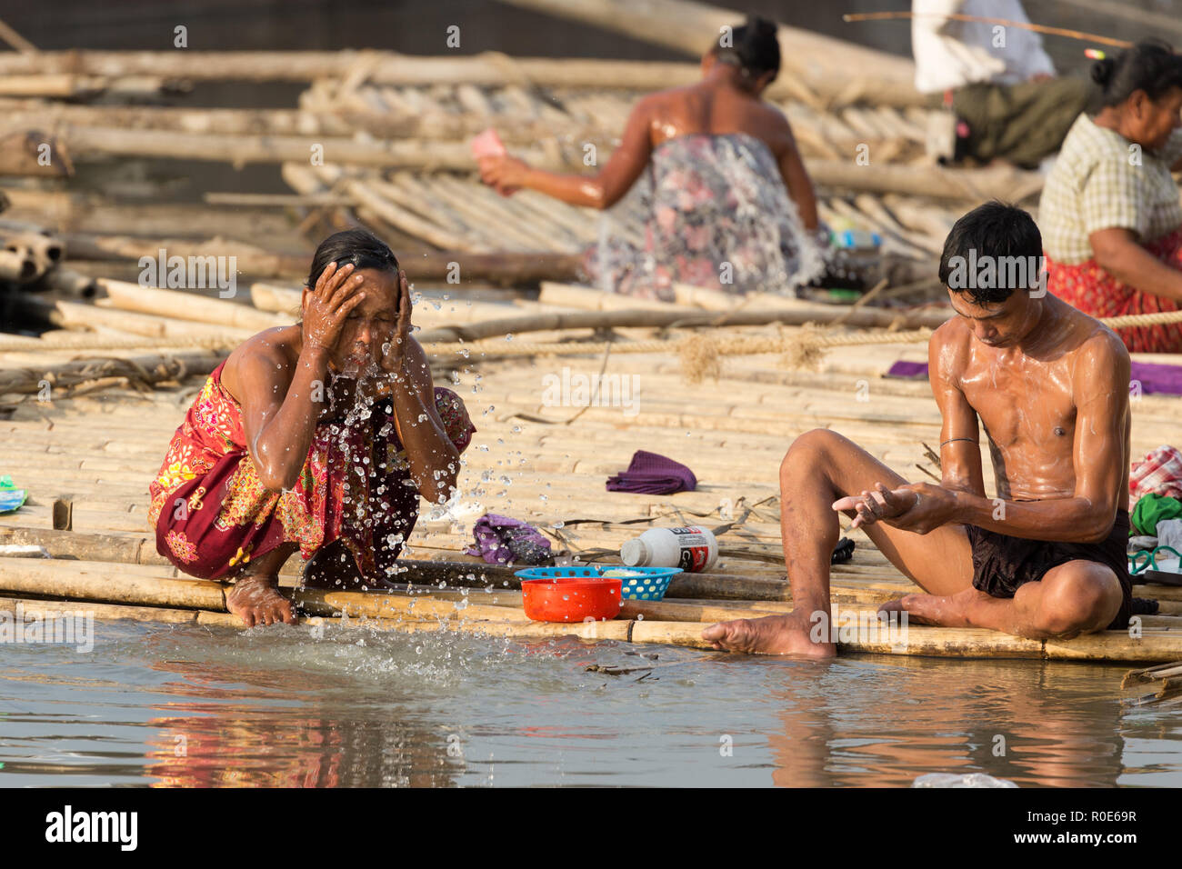 MANDALAY,MYANMAR,JANUARY 19, 2015 : Women taking shower and washing ...