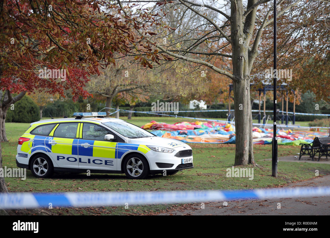 A deflated inflatable slide (rear, coloured red) sits on the ground in ...